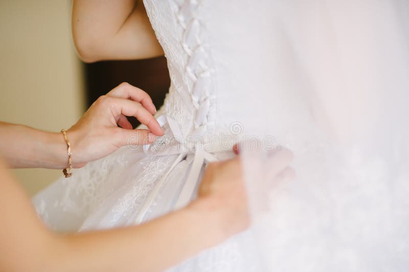Bride getting dressed stock photo. Image of women, view - 51757334