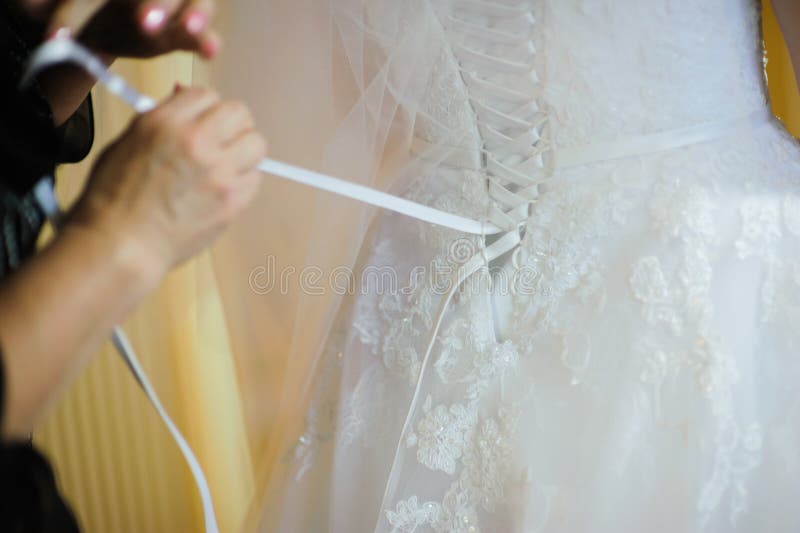 Bride Getting Dressed on Her Wedding Day Stock Photo - Image of gown ...