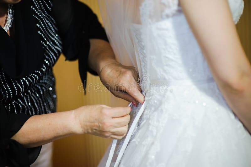 Bride Getting Dressed on Her Wedding Day Stock Image - Image of ...
