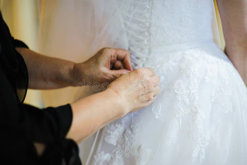 Bride Getting Dressed on Her Wedding Day Stock Photo - Image of ...