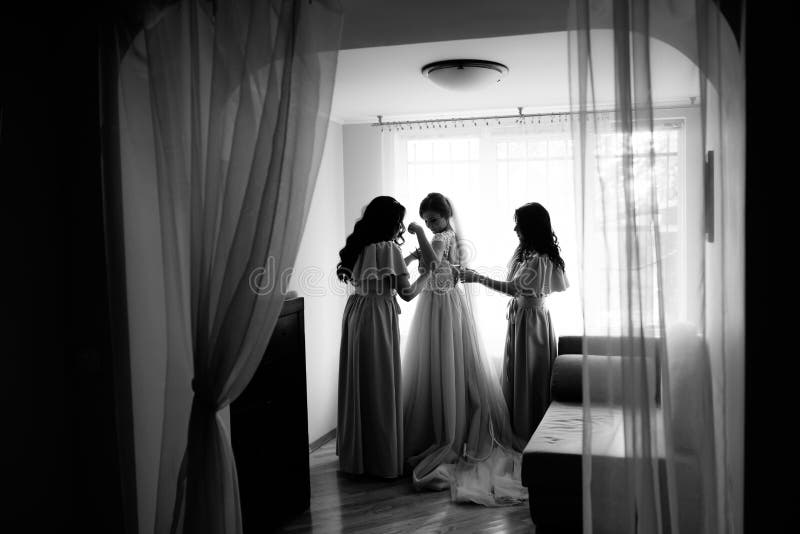 A Bride Getting Dressed for the Wedding and Being Helped by Her ...