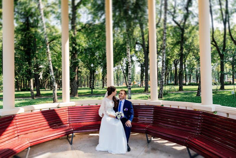 Bride and groom on a bench stock photo. Image of celebration - 91486454