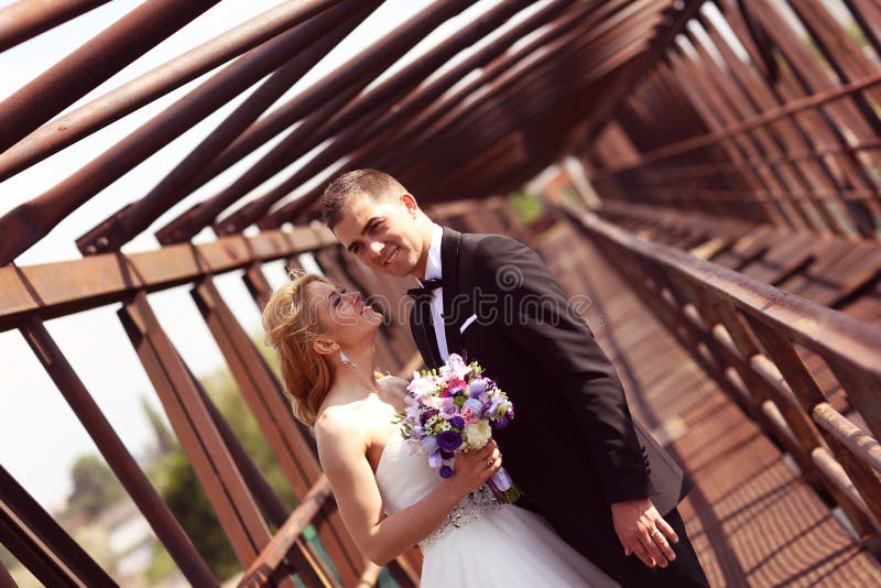 Bride and Groom on a Bridge Stock Image - Image of outdoors, adults ...