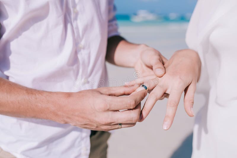 Bride and Groom Change Rings at Their Wedding on the White Sand Beach ...