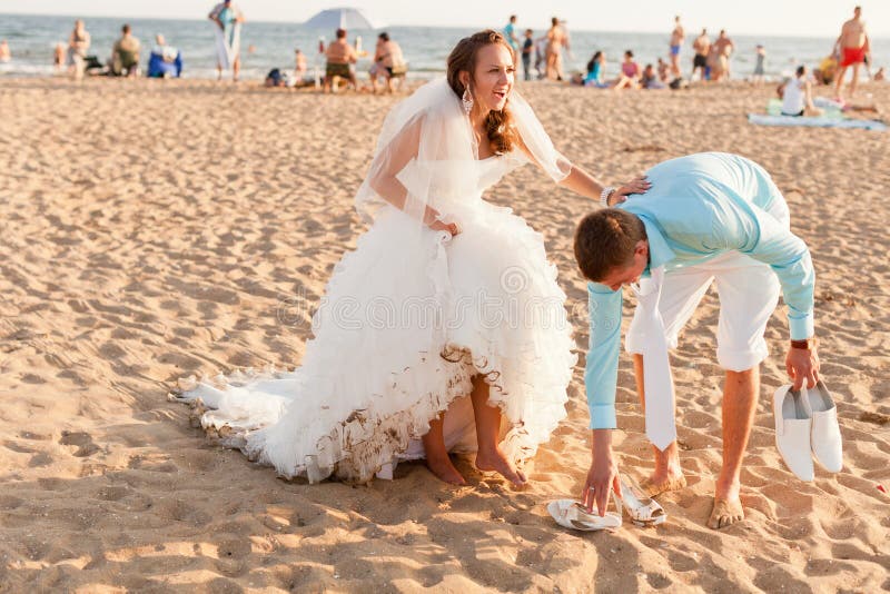 Bride and Groom at the Crowded Beach Stock Photo - Image of sunlight ...