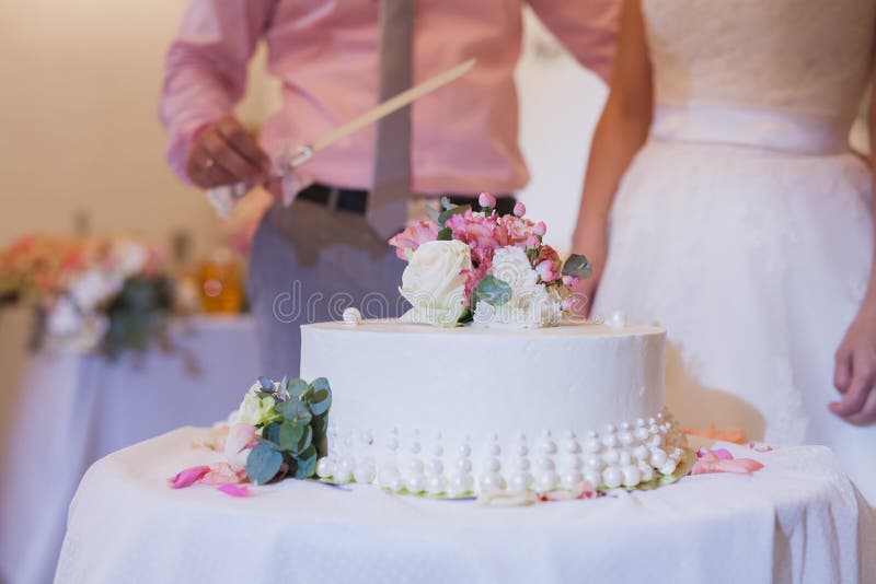 The Bride and Groom Cut the Wedding Cake. Stock Photo - Image of ...
