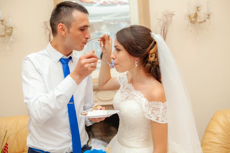 Bride and Groom Eat Wedding Cake Stock Photo - Image of marriage, happy ...