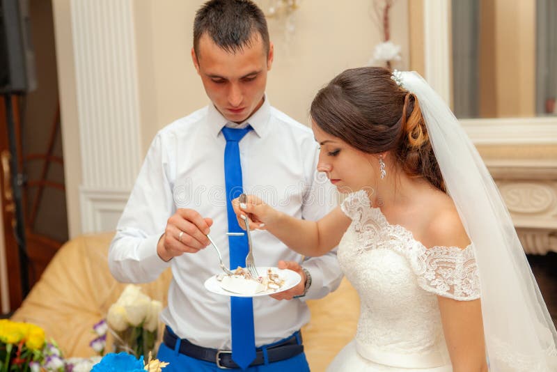 Bride and Groom Eat Wedding Cake Stock Photo - Image of food, male ...