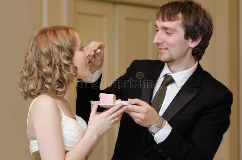 Bride and Groom Eating Wedding Cake Stock Photo - Image of engagement ...