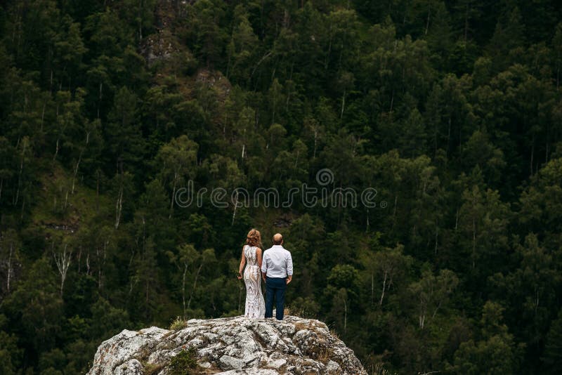 Wedding Couple on the Edge of the Mountain. Wedding Travel. Loving ...