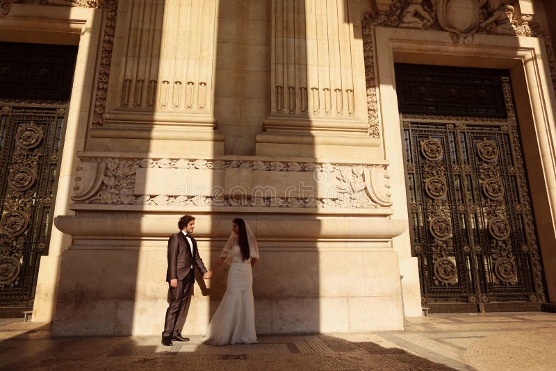 Bride and Groom in Front of a Big Building Stock Image - Image of arms ...