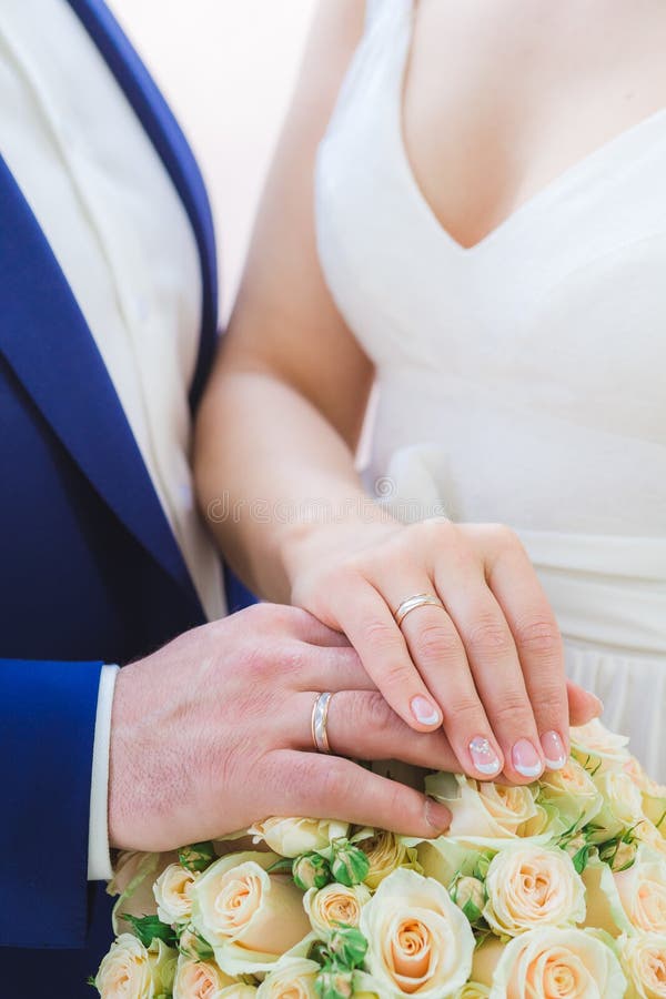 Bride and Groom Hands and Rings on Wedding Bouquet Stock Photo - Image ...