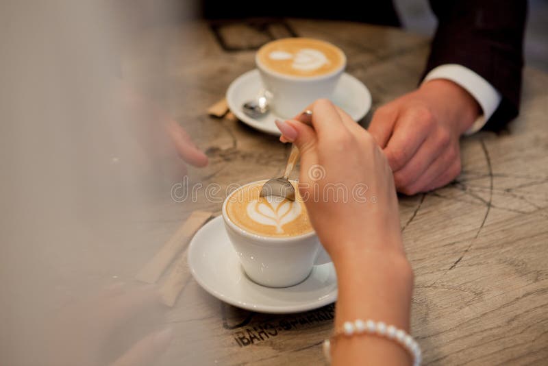 Bride and Groom Hold Cups with Cappuccino and Look at Each Other Stock ... Bride and Groom Hold Cups with Cappuccino and Look at Each Other Stock ...