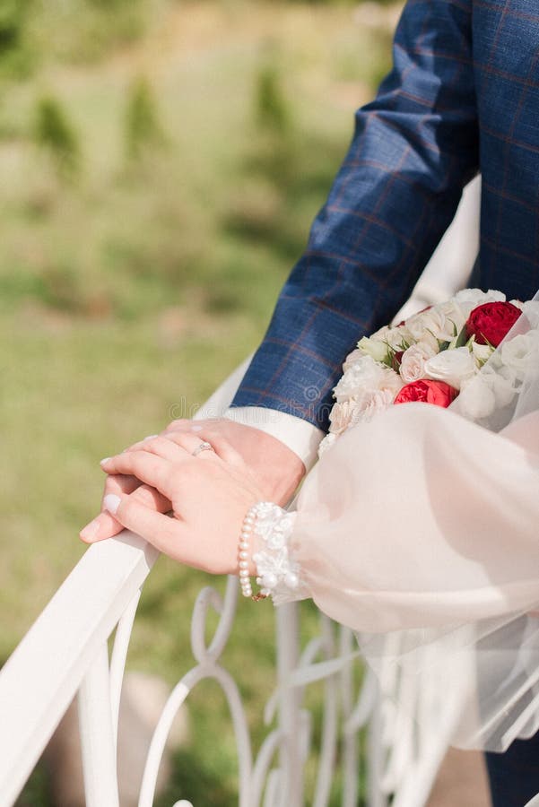 Bride and Groom Holding Hands, Bridal Bouquet Stock Photo - Image of ...