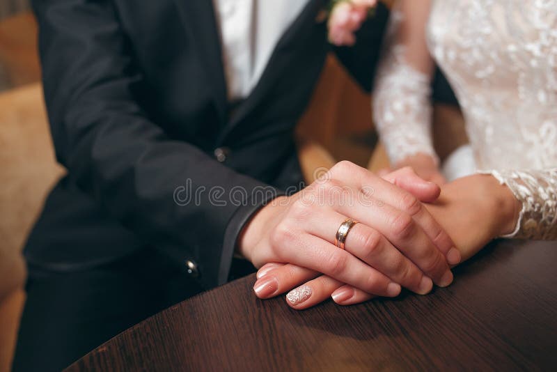 Bride and Groom Holding Hands with Wedding Rings on it Stock Image ...
