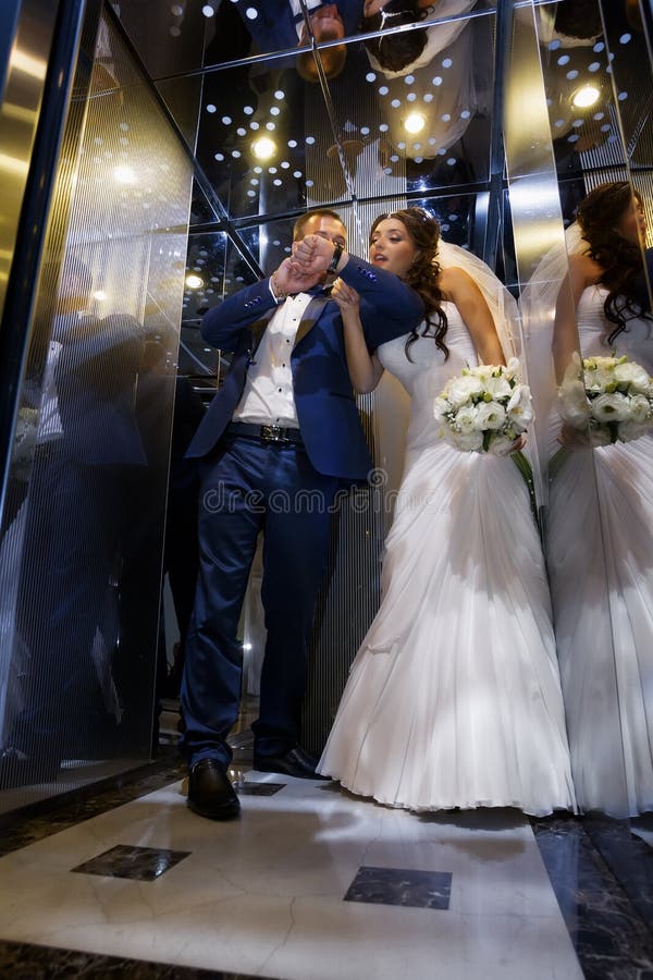 Bride and groom in lift stock image. Image of embracing - 42415617