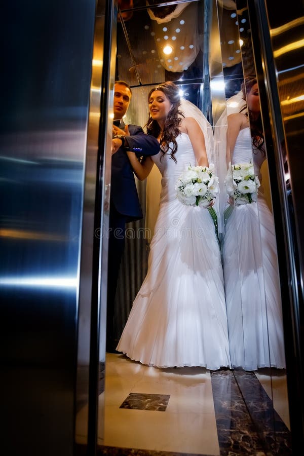 Bride and groom in lift stock photo. Image of late, bride - 85064090