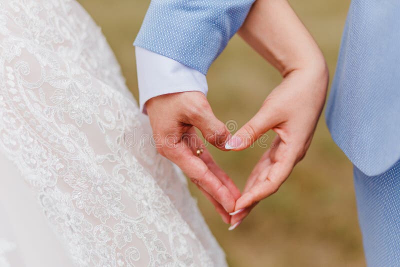 The Bride and Groom Make Heart Hands Stock Image - Image of romance ...