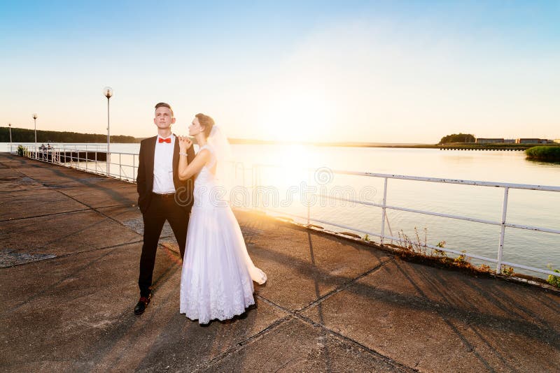 Bride and Groom on the Pier at Sunset. Stock Image - Image of happiness ...