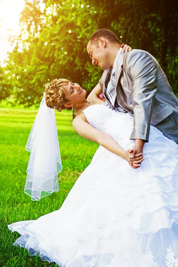 Wedding Couple Kiss in the Park Stock Photo - Image of sunlight ...