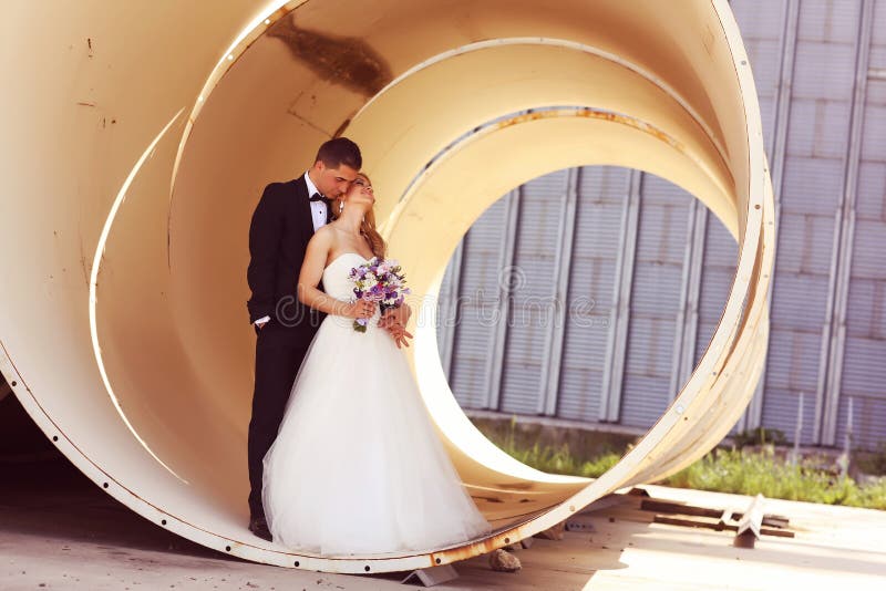 Bride and Groom Posing in a Big Pipe Stock Photo - Image of male ...