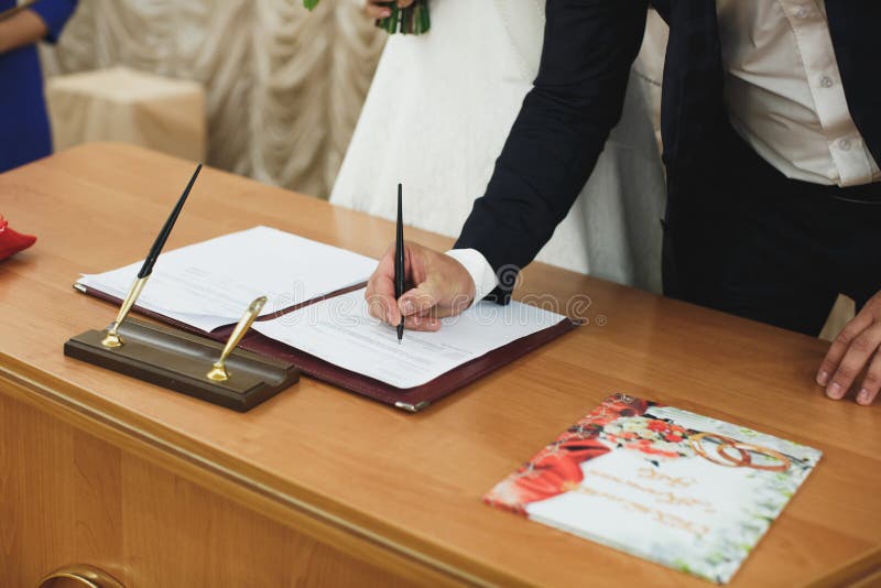 Bride and Groom Signing Marriage Wedding Certificate at Registry. Stock ...