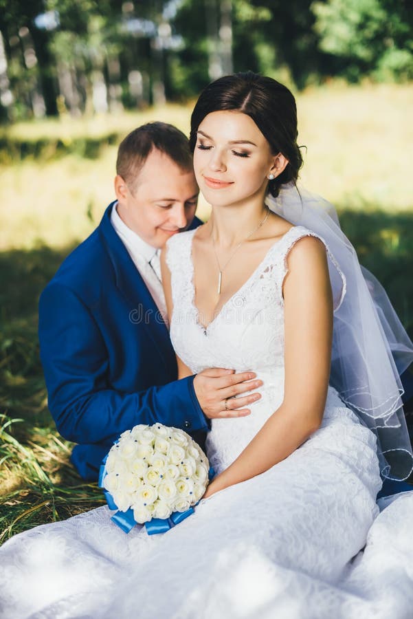 Bride Sitting on Green Grass at Park Stock Photo - Image of female ...