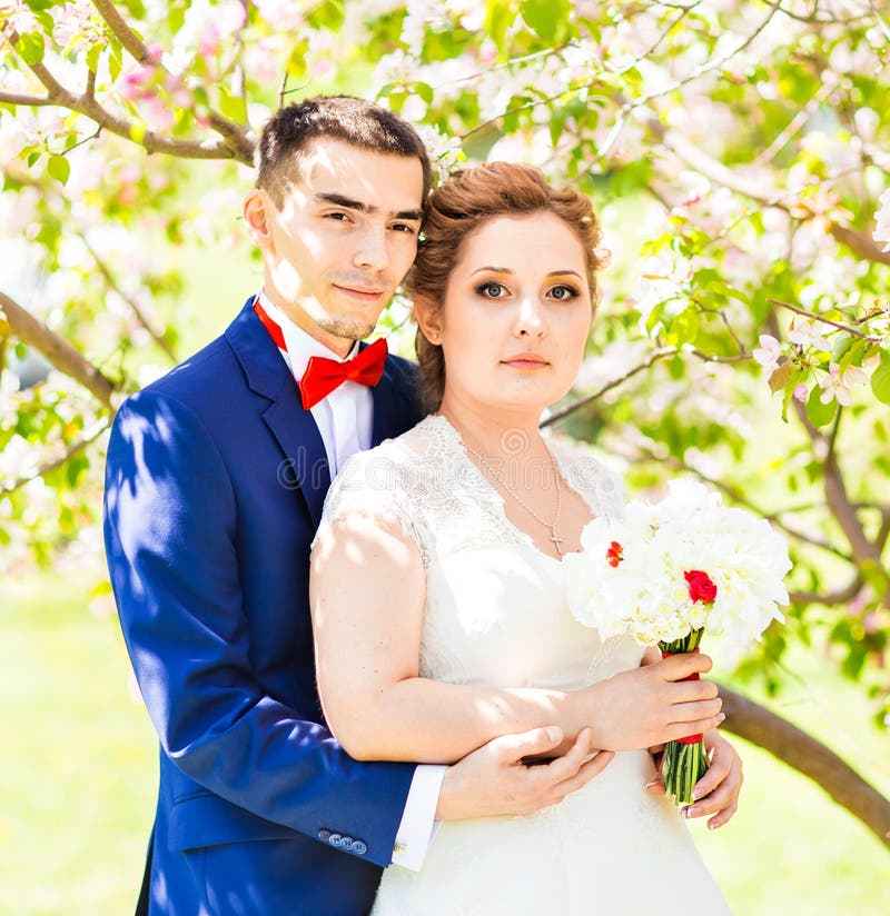 The Bride and Groom in the Spring Nature with Blooming Trees Stock ...