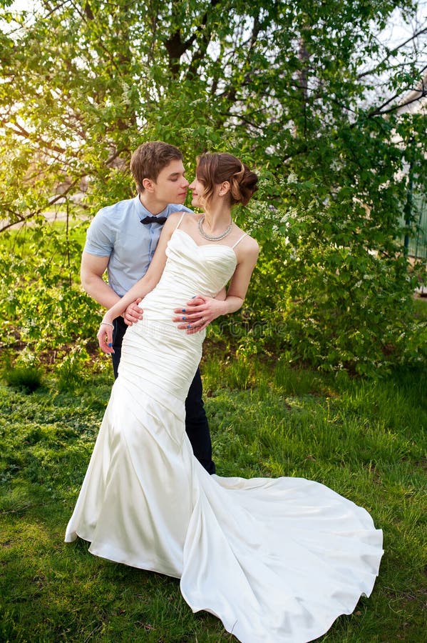 Bride and Groom Stand Near a Flowering Tree in Spring Garden Stock ...