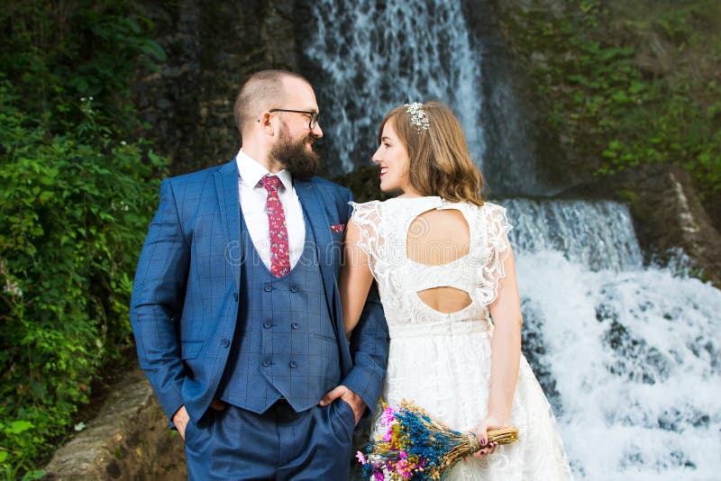 Wedding Couple Standing in Front of a Waterfall Stock Image - Image of ...