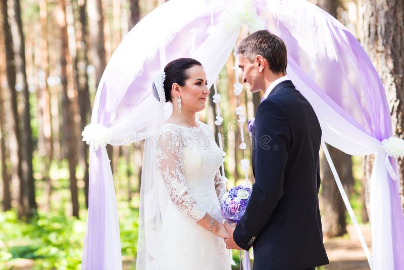 Bride and Groom Under Wedding Arch Stock Photo - Image of diversity ...