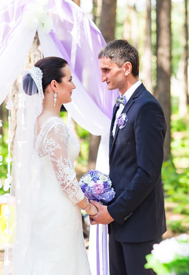 Bride and Groom Under Wedding Arch Stock Photo - Image of celebrations ...