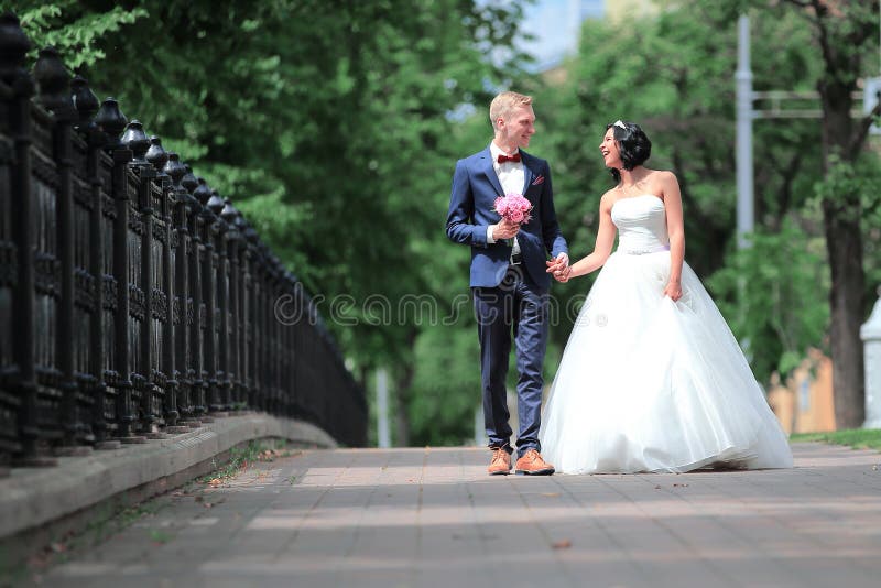 Bride and Groom Walk Together Down the Street Stock Image - Image of ...