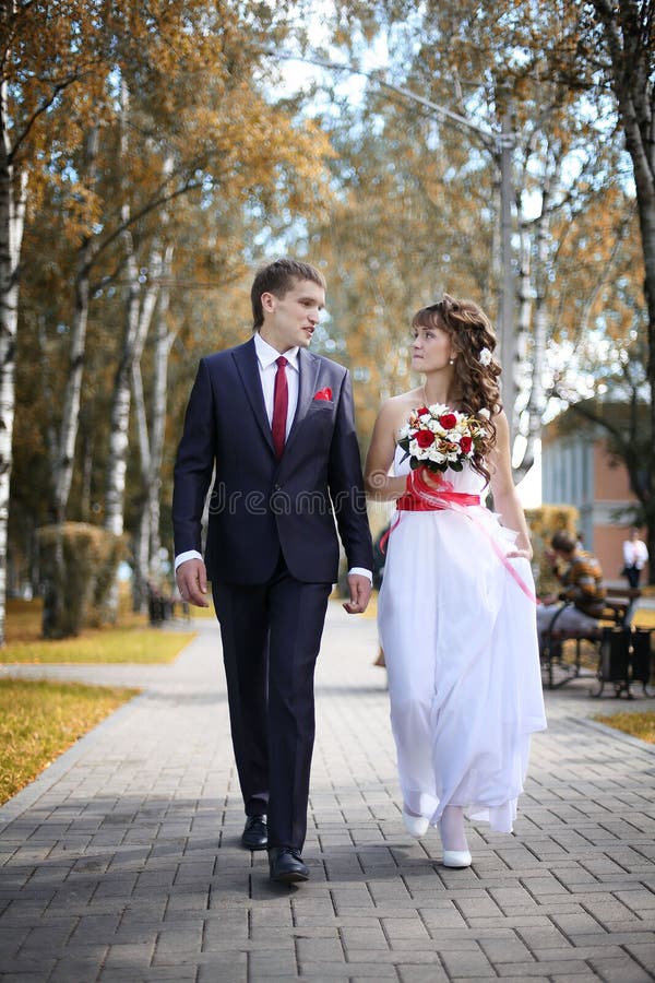 Bride and groom walking stock image. Image of love, park - 64157573