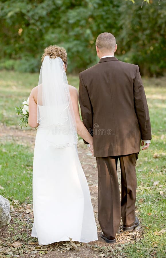 Bride and Groom Walking Away Stock Photo - Image of floral, couples: 179130