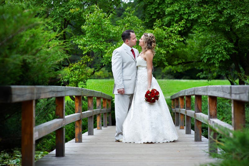 Bride and Groom on a Wooden Bridge Stock Photo - Image of smile ...