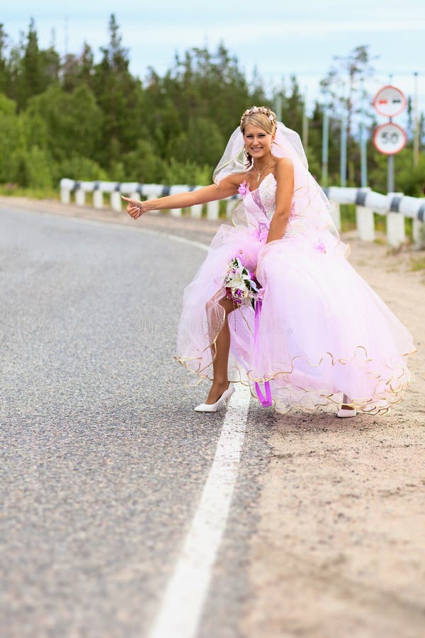 Bride hitching on a road stock photo. Image of person - 23480622
