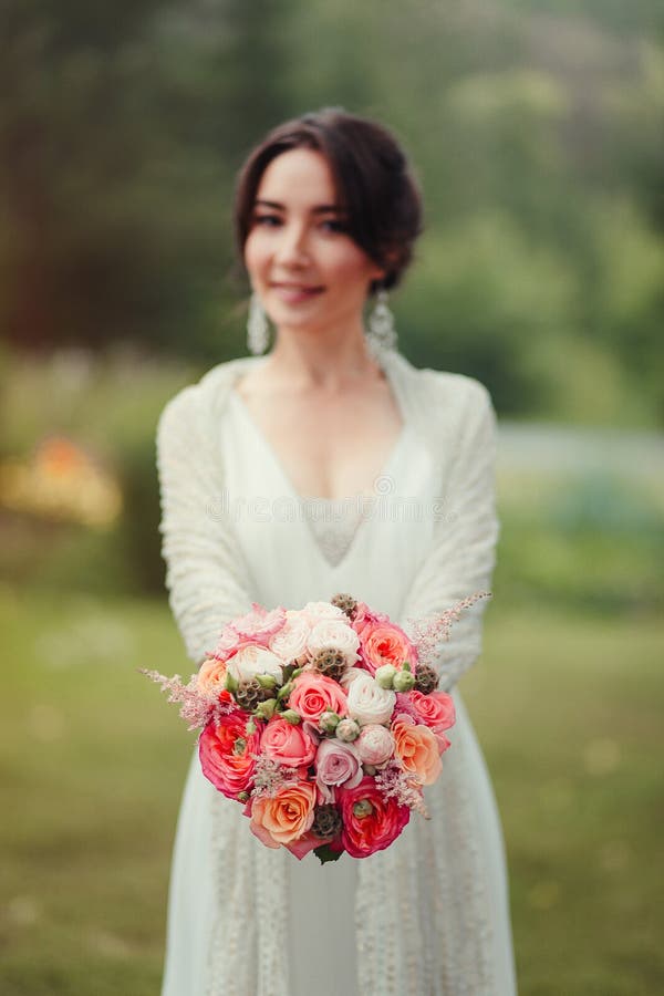Bride Holding a Bouquet of Flowers in a Rustic Style, Wedding Bo Stock ...