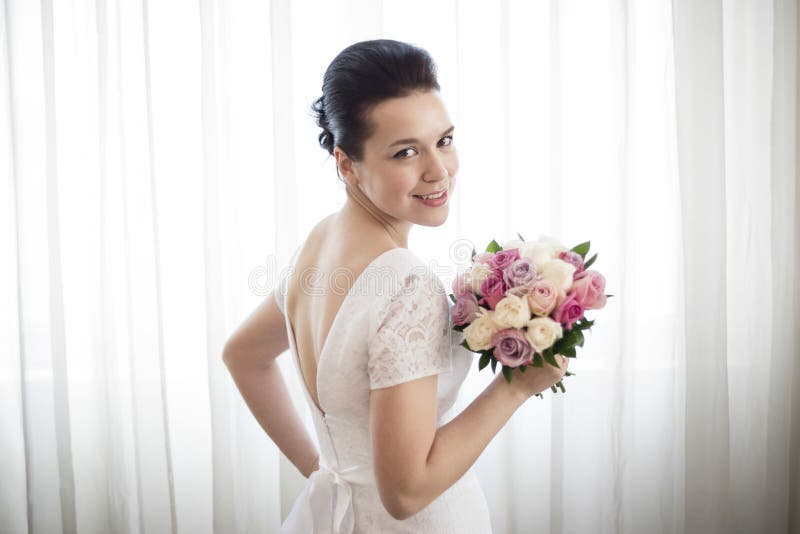 Bride Holding a Bouquet of Roses Stock Photo - Image of pretty ...
