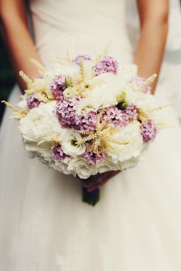 Bride Holds in Her Hands a Bouquet of White Roses and Violet Lilacs ...