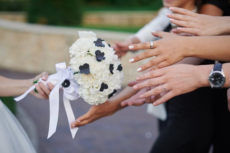 Bride Holds a Wedding Bouquet and Hands Reaching for it Stock Image ...