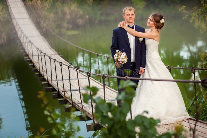 Bride on Long Suspension Bridge Stock Photo - Image of young, color ...