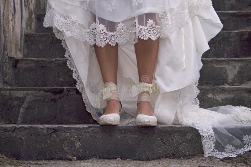 Bride`s Legs in White Stockings with Lace Garter and Rhinestones, the ...