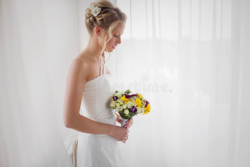 Bride Looking Down at Her Wedding Bouquet Stock Image - Image of bride ...