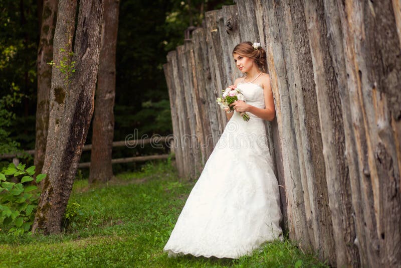 Bride Near Wooden Rustic Fence in Park Stock Photo - Image of wedding ...