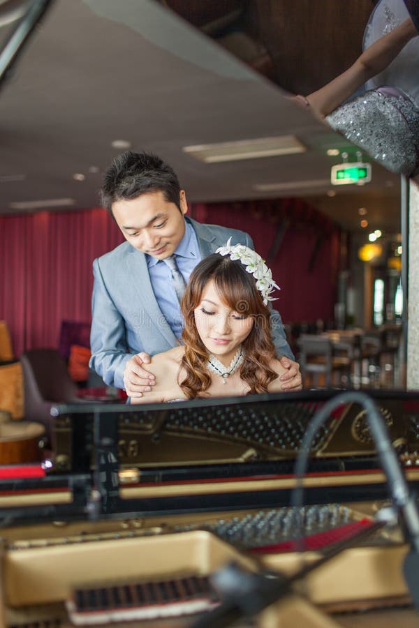 Bride is playing piano stock image. Image of traditional - 28379843