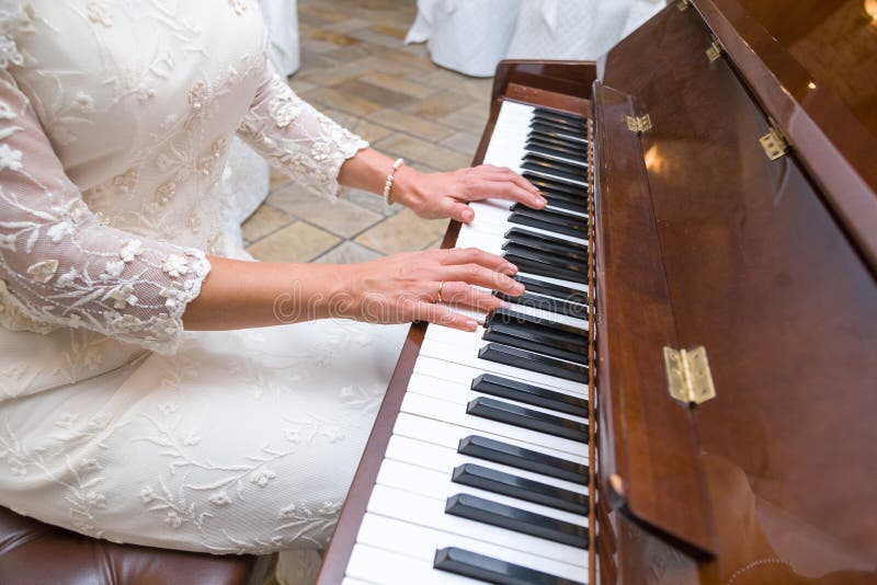 Bride plays piano stock image. Image of female, piano - 46388877