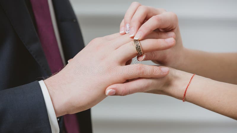 Bride Putting a Wedding Ring on Grooms Finger. Stock Photo - Image of ...