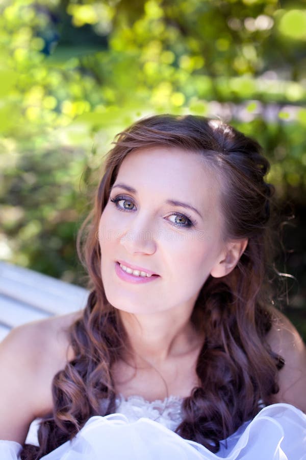 Bride relaxing in the park stock image. Image of newlywed - 33923601