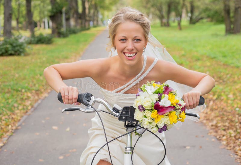 Happy Bride Riding A Bike Picture. Image: 15054098